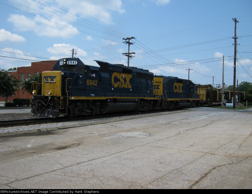 CSX 6942 and companion road slug pulls rail train WO18 through West Point, GA. The train would ...